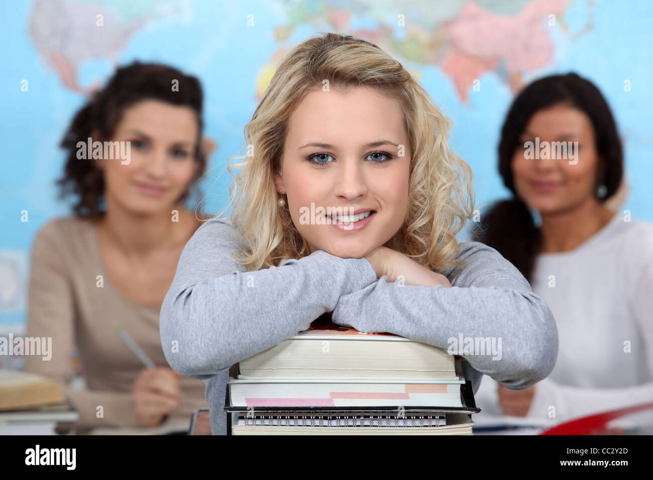 Three teenage girls in class room Stock Photo - Alamy