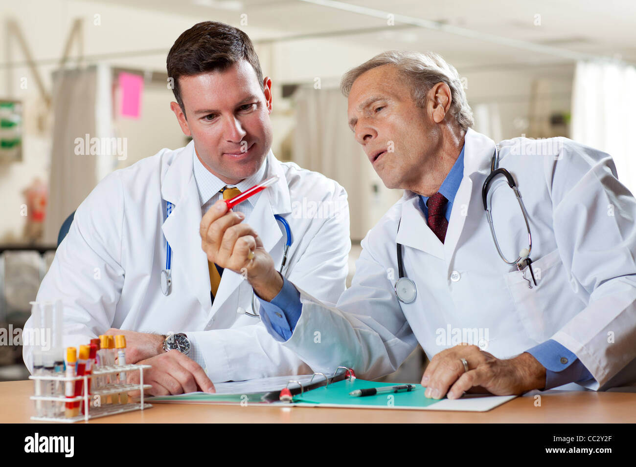 USA, Arizona, Phoenix, Two doctors examining test tube in hospital ...