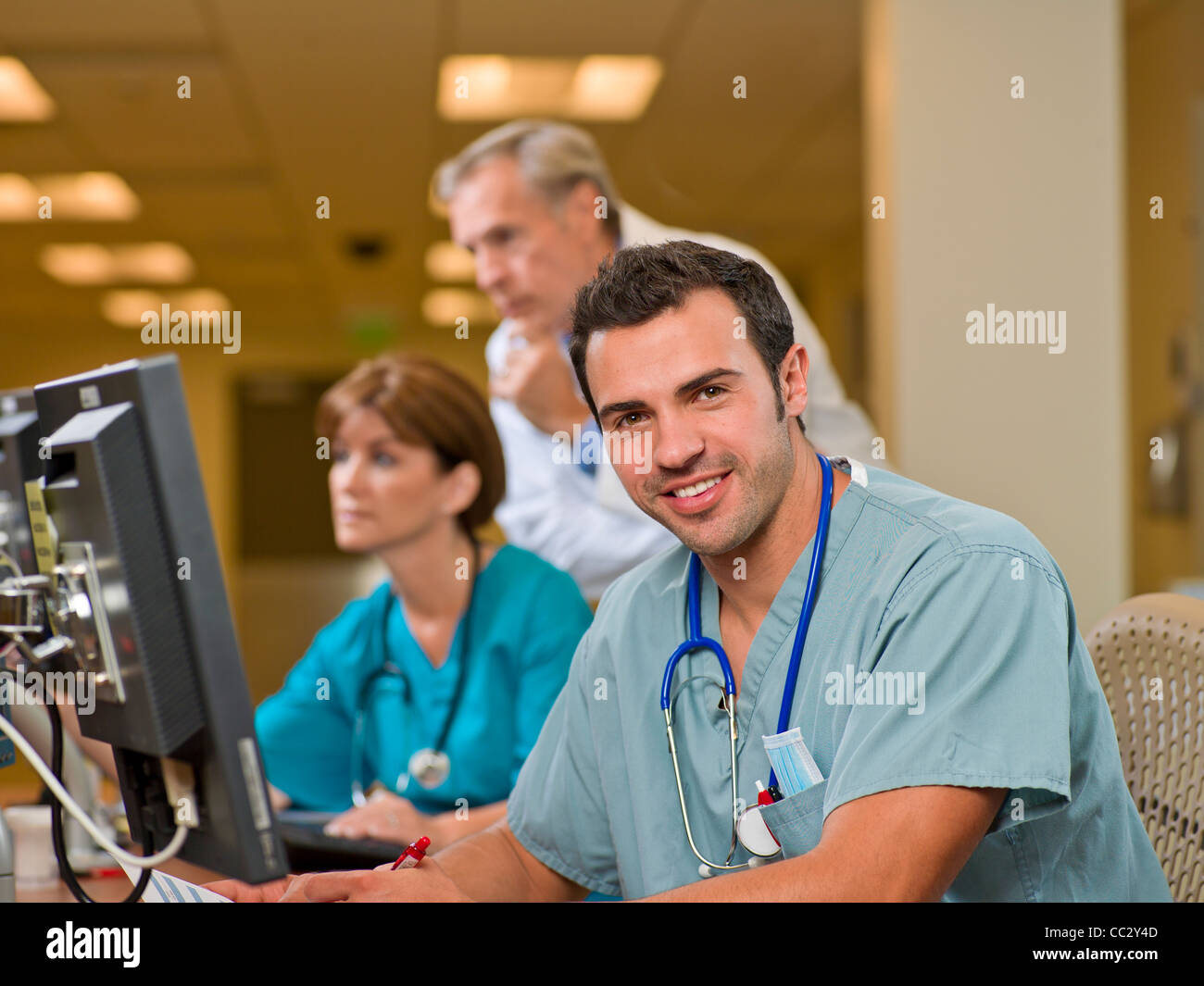 USA, Arizona, Phoenix, Doctor and surgeons working on computers in ...