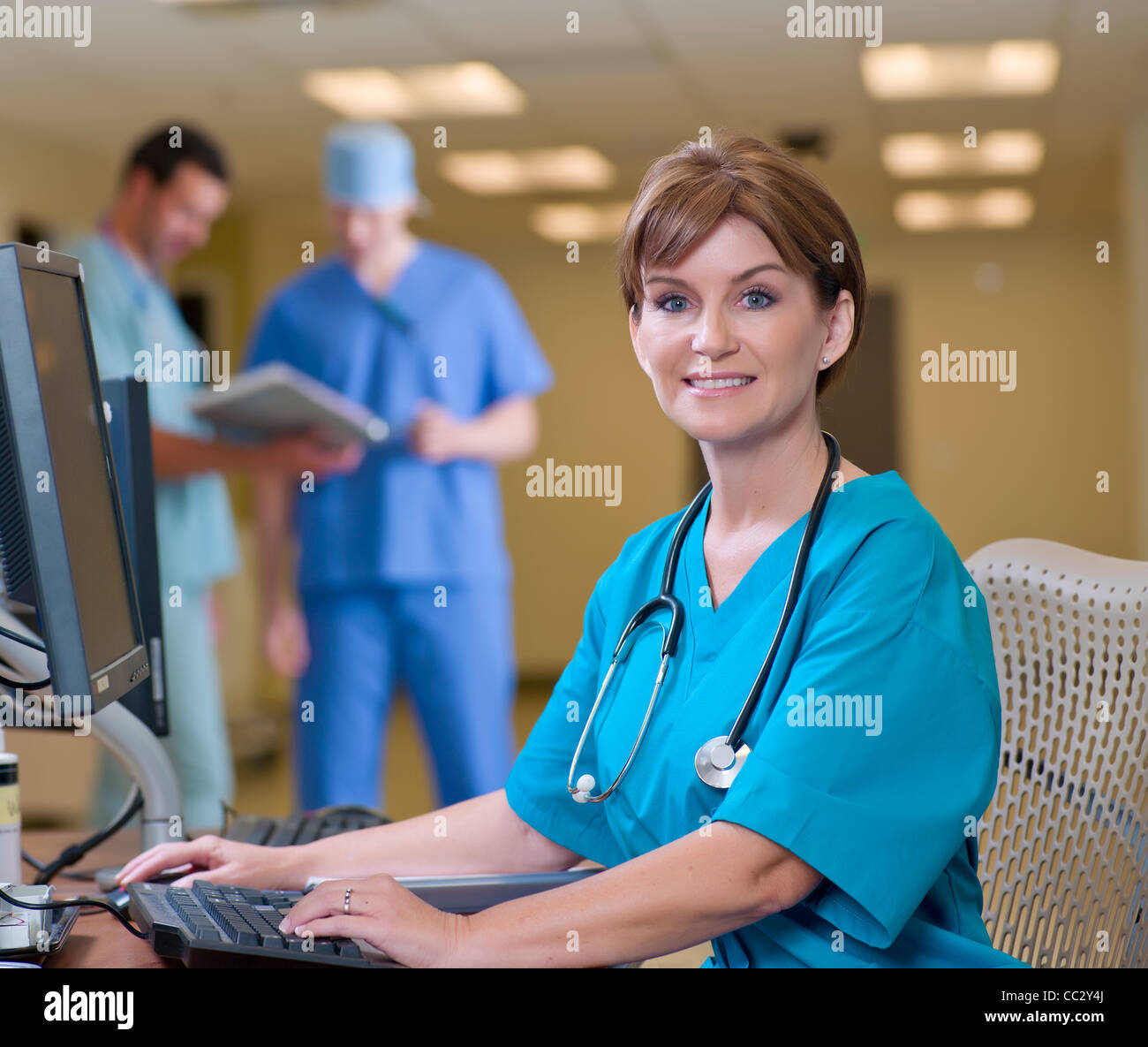 USA, Arizona, Phoenix, Female surgeon working on computer in hospital ...