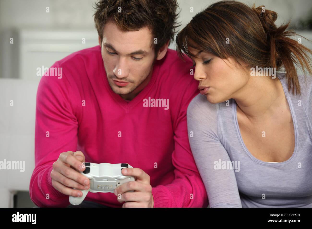 Young man and young woman playing video games Stock Photo - Alamy