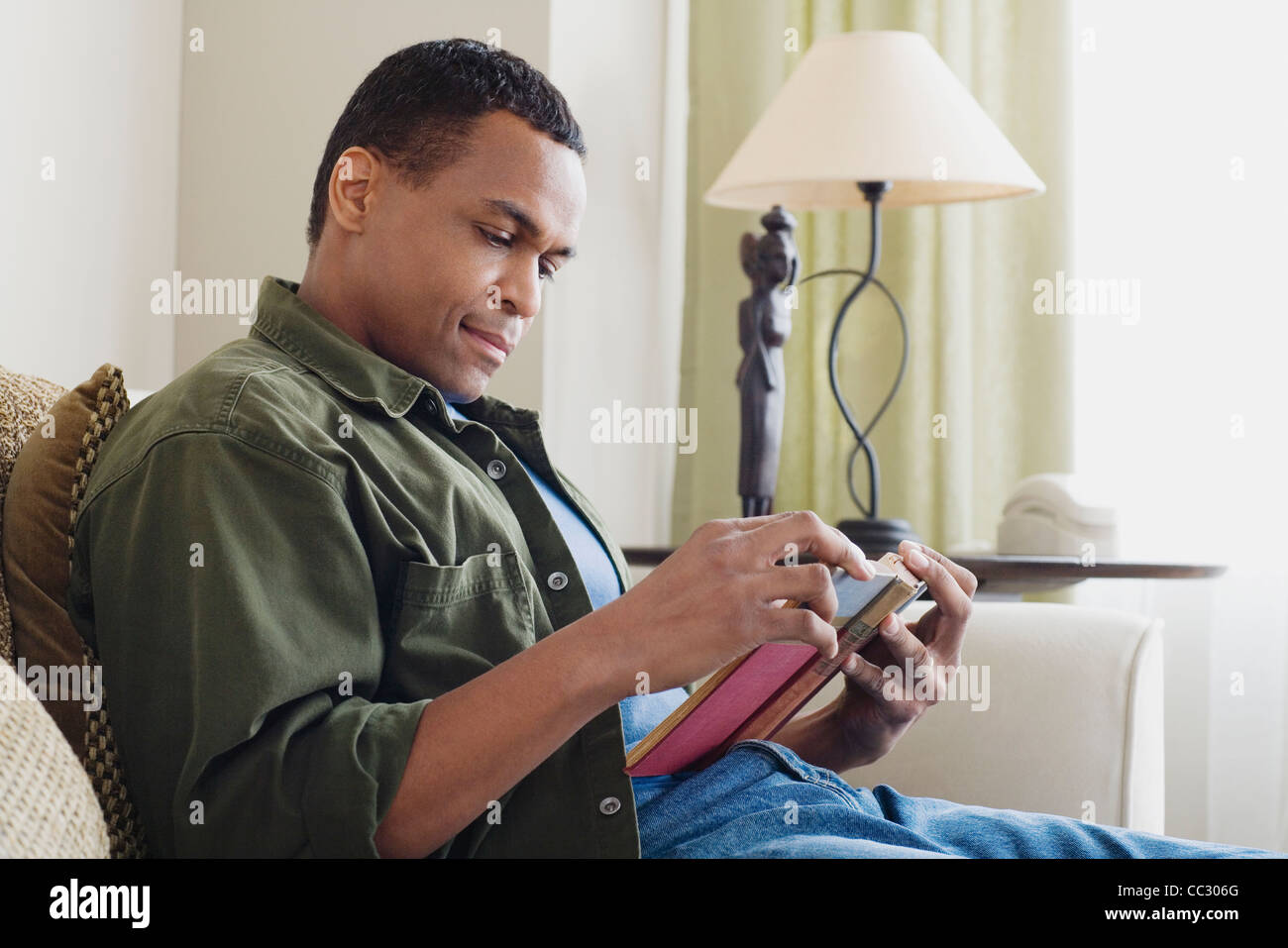 Man reading book at home 40 44 years hi-res stock photography and ...