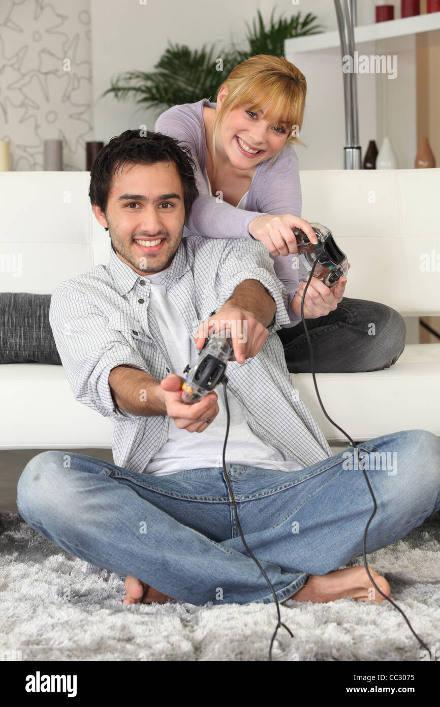 Young couple playing video games Stock Photo - Alamy