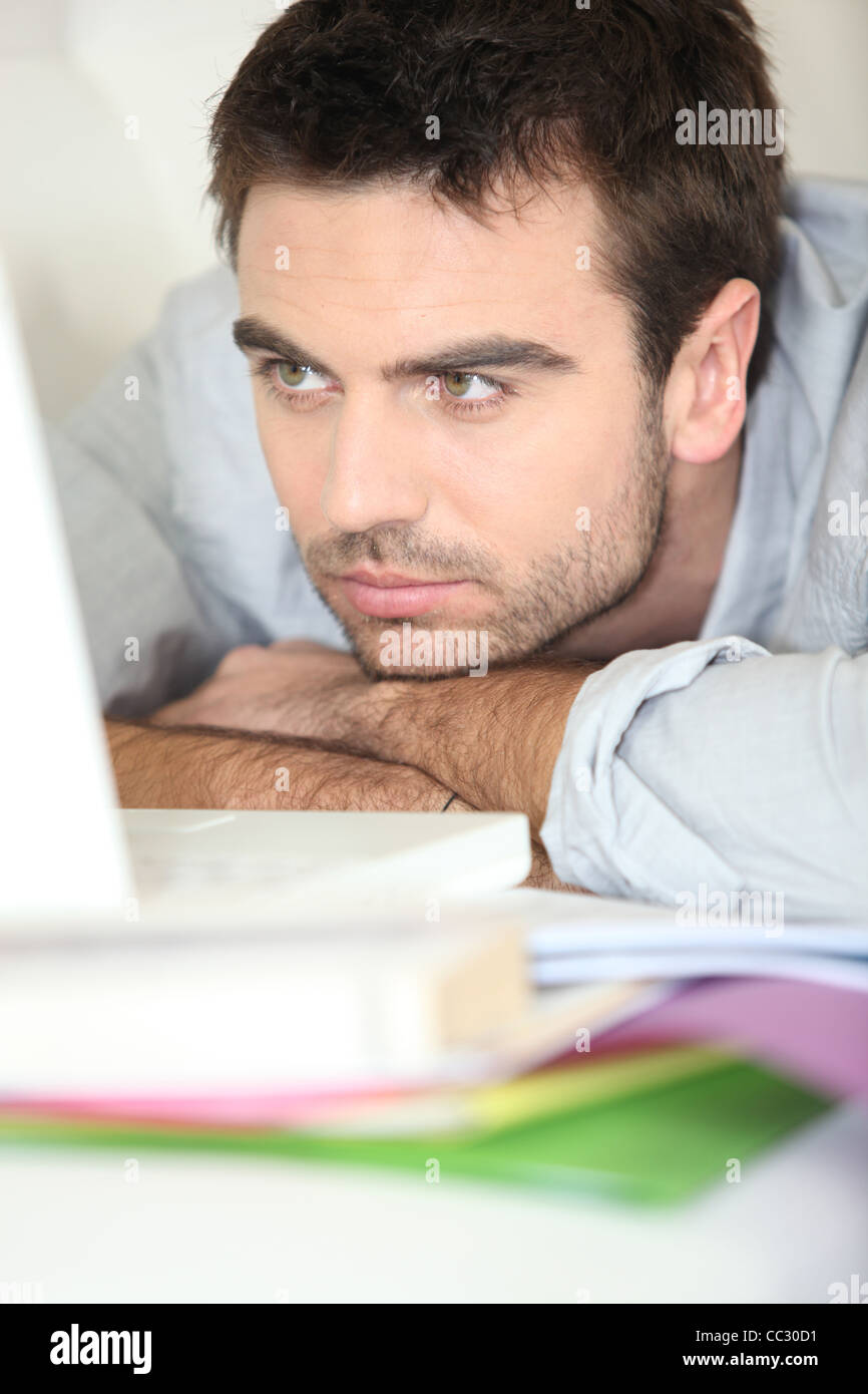 Man sick of studying Stock Photo - Alamy