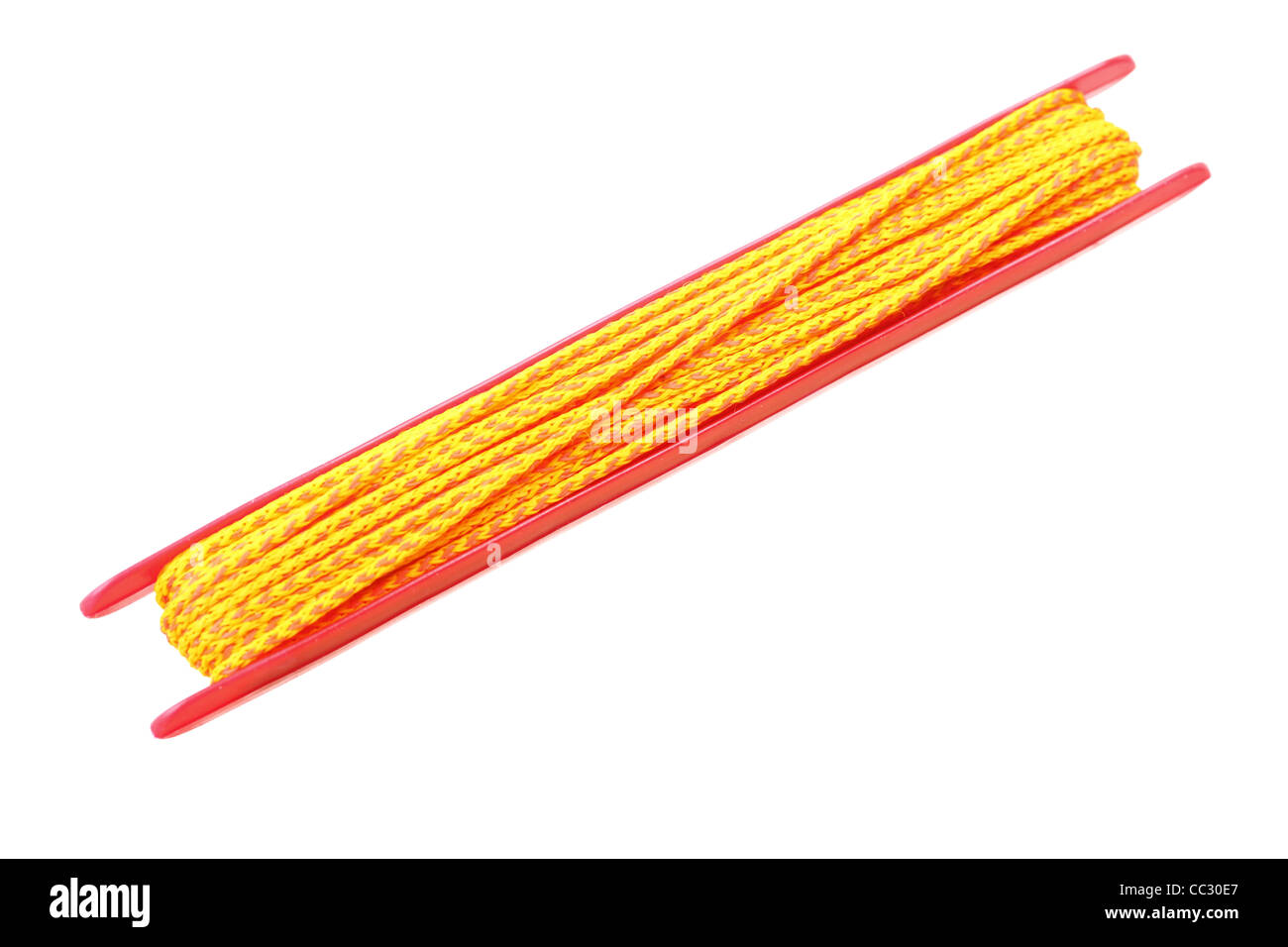 Rolled yellow rope isolated on white. Studio shot Stock Photo - Alamy