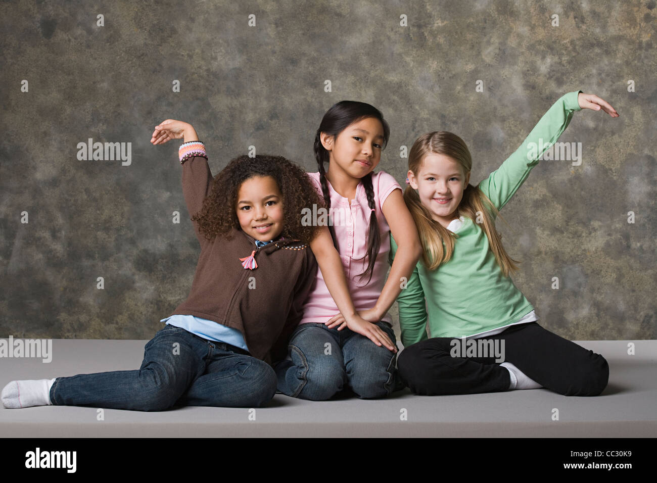 Three girls (8-9) posing, studio shot Stock Photo - Alamy
