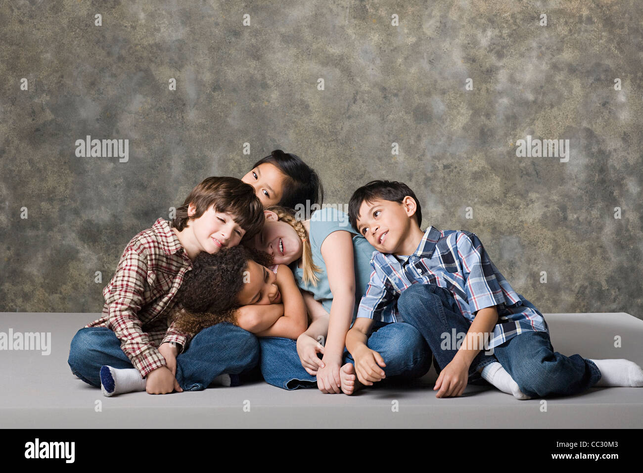 Tired children (6-7, 8-9) lying together, studio shot Stock Photo - Alamy