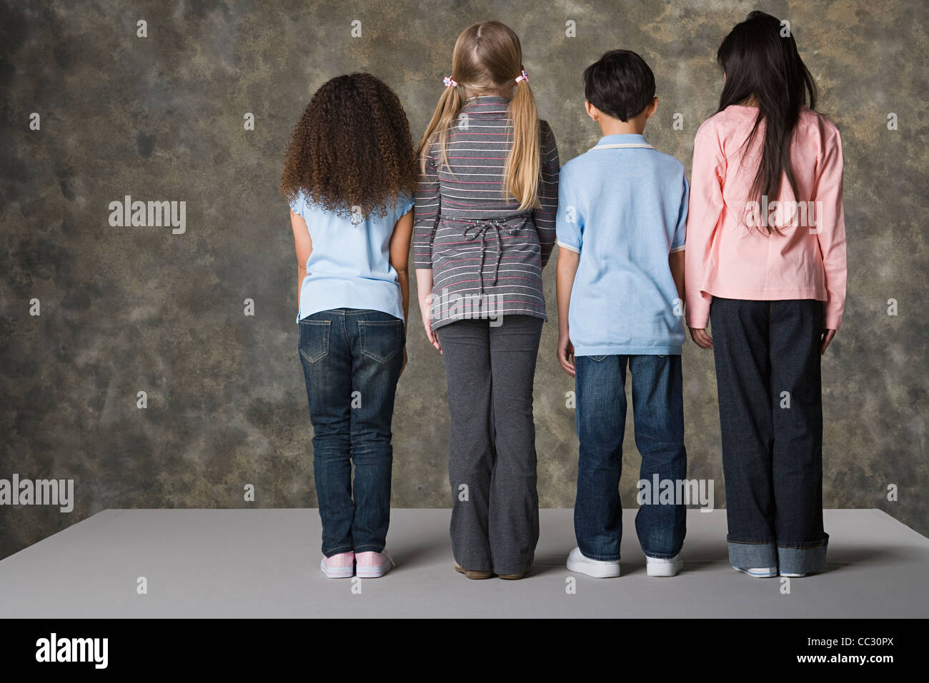 Rear view of children (8-9) standing, studio shot Stock Photo - Alamy
