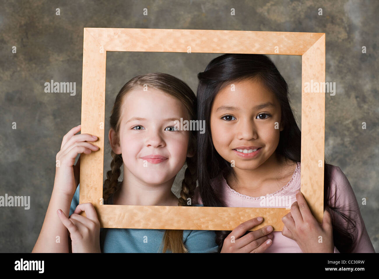 Girls looking through picture frame hi-res stock photography and images ...