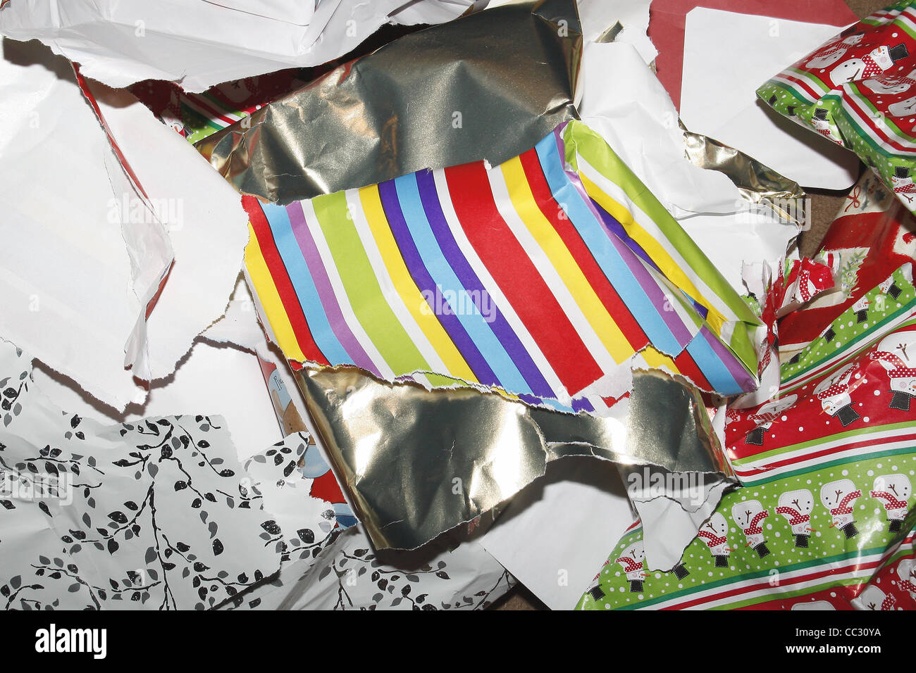 image of torn and ripped xmas wrapping paper Stock Photo - Alamy