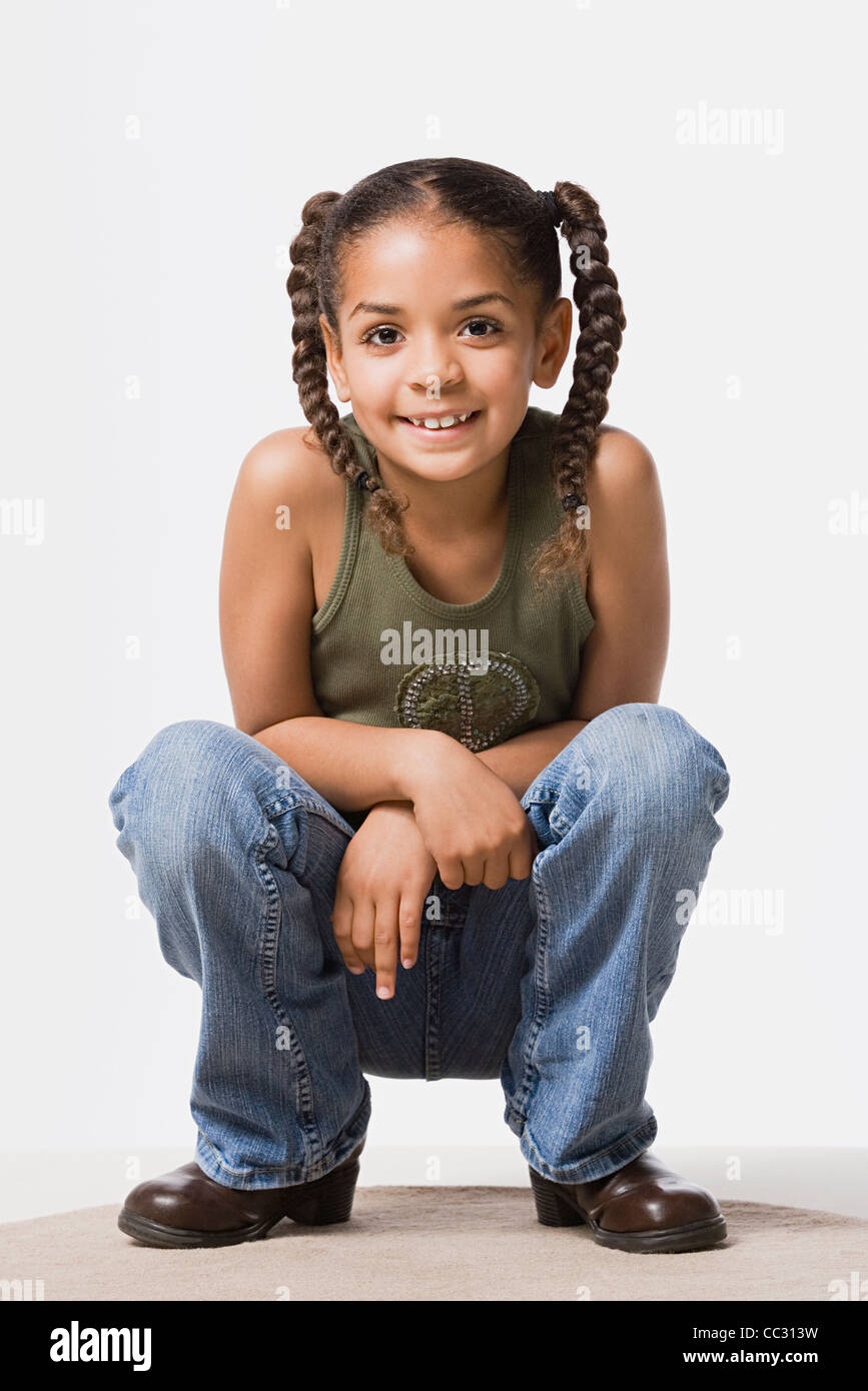 Studio portrait of smiling girl (8-9) with plaits Stock Photo - Alamy