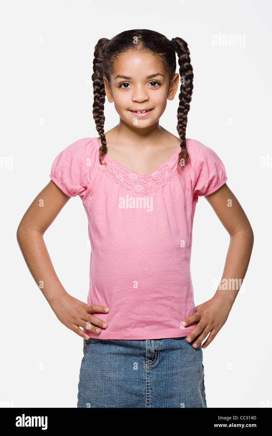 Studio portrait of smiling girl (8-9) with plaits Stock Photo - Alamy