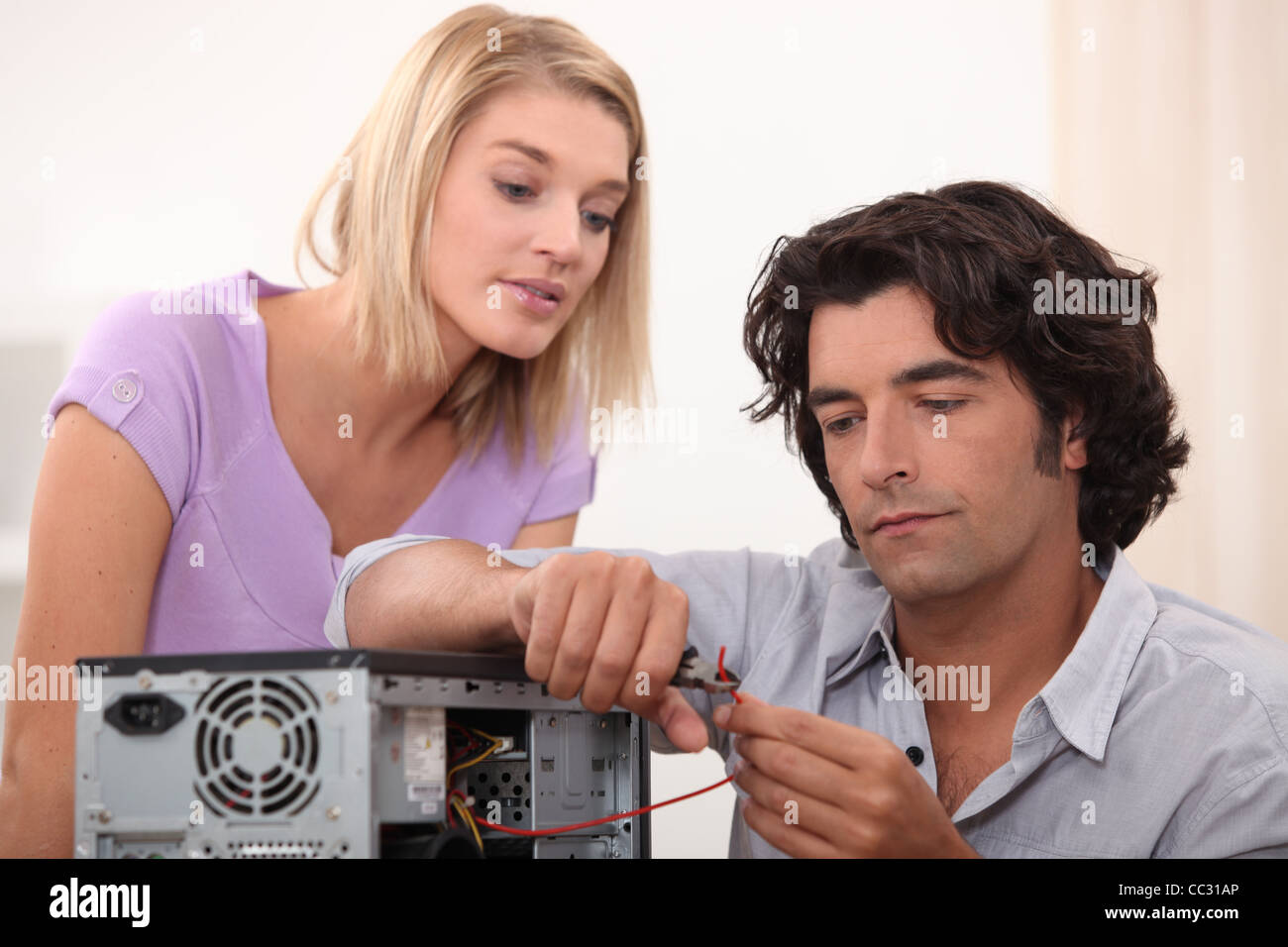 Man cutting a wire Stock Photo - Alamy
