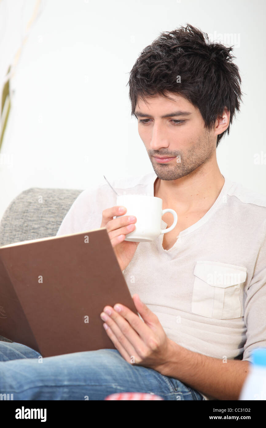 Man reading book drinking hot hi-res stock photography and images - Alamy