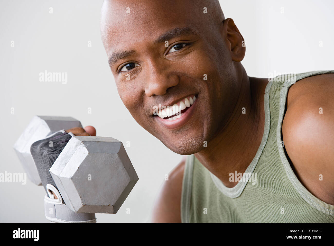 USA, California, Los Angeles, Portrait of smiling young man lifting ...