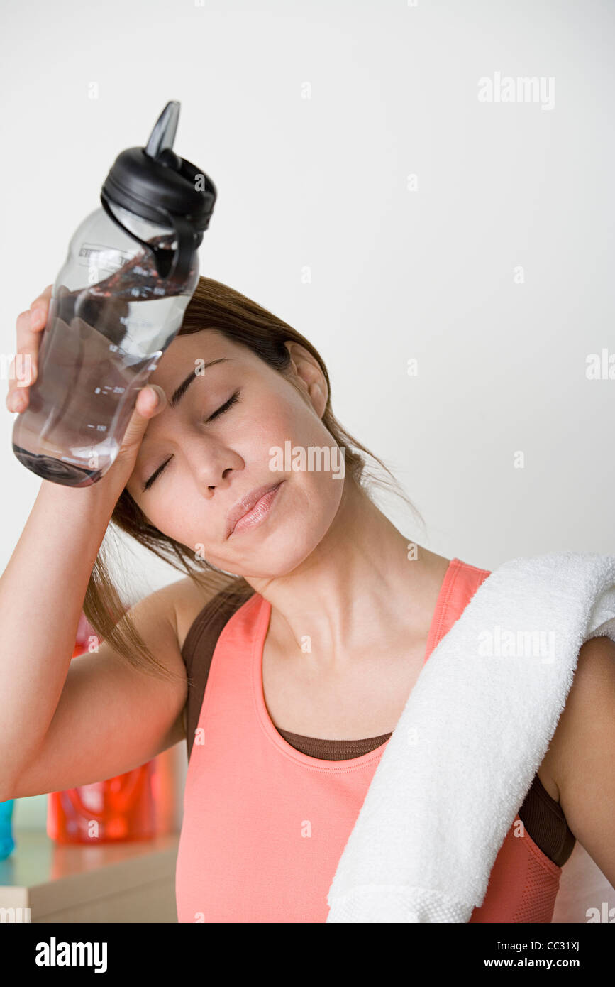 USA, California, Los Angeles, Tired female athlete wiping out sweat ...