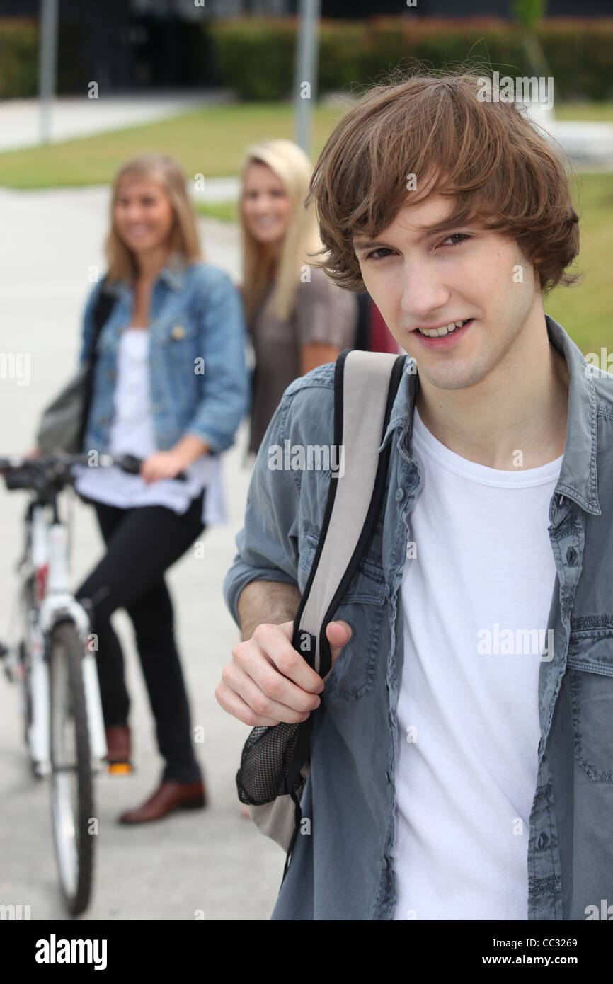 Three teenagers arriving at college Stock Photo - Alamy