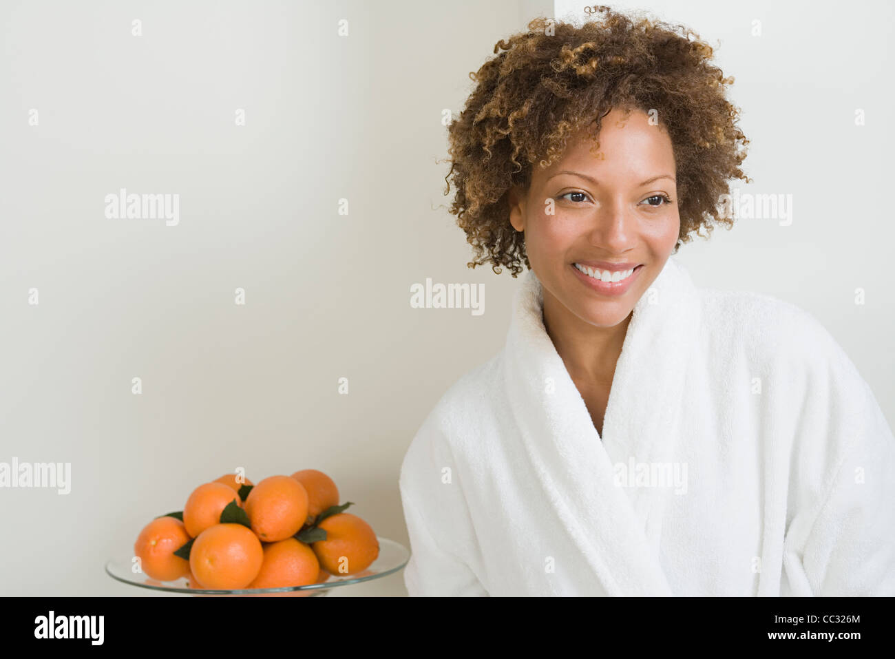 USA, California, Los Angeles, Portrait of attractive woman with oranges ...