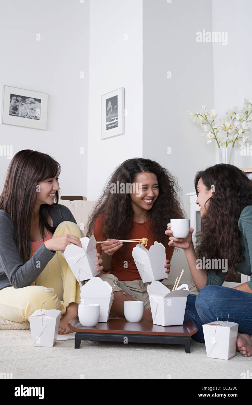 USA, California, Los Angeles, Young women eating take out food at home ...