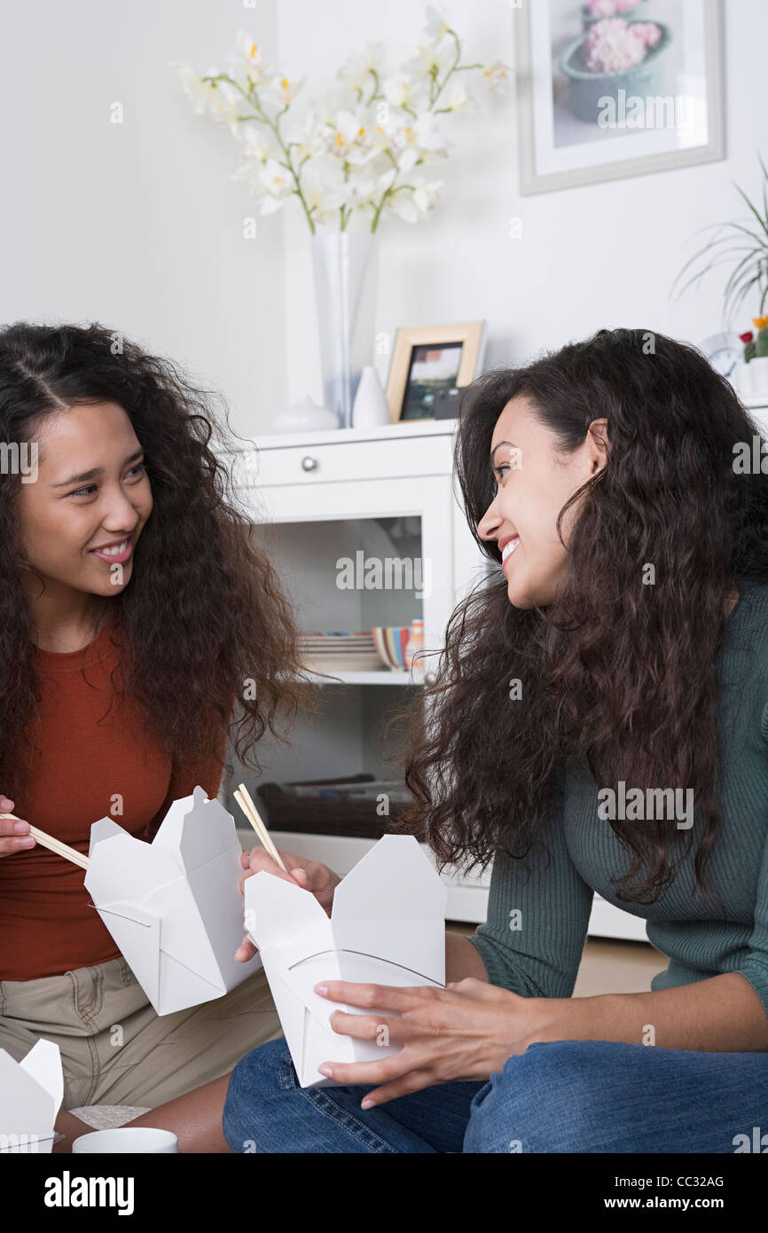 USA, California, Los Angeles, Young women eating take out food at home ...