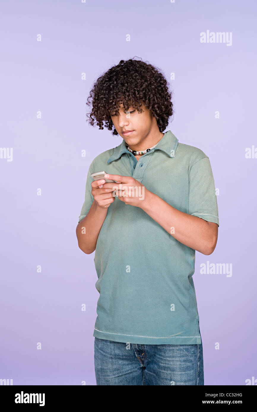 Portrait of teenage boy (14-15) texting on mobile phone Stock Photo - Alamy