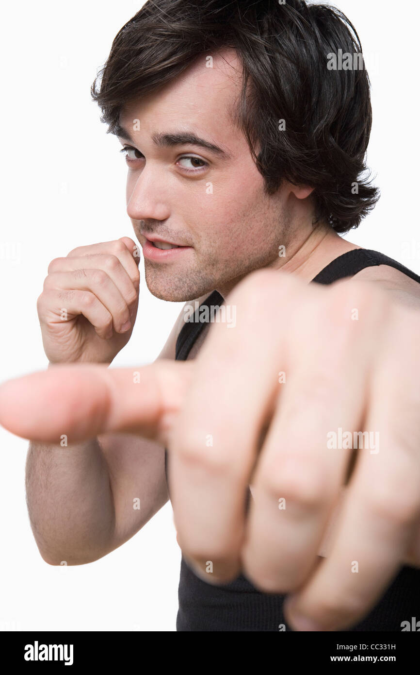 Studio portrait of young man punching air Stock Photo - Alamy
