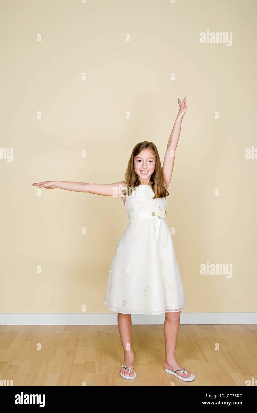 Portrait of happy girl (8-9) dressed in white Stock Photo - Alamy
