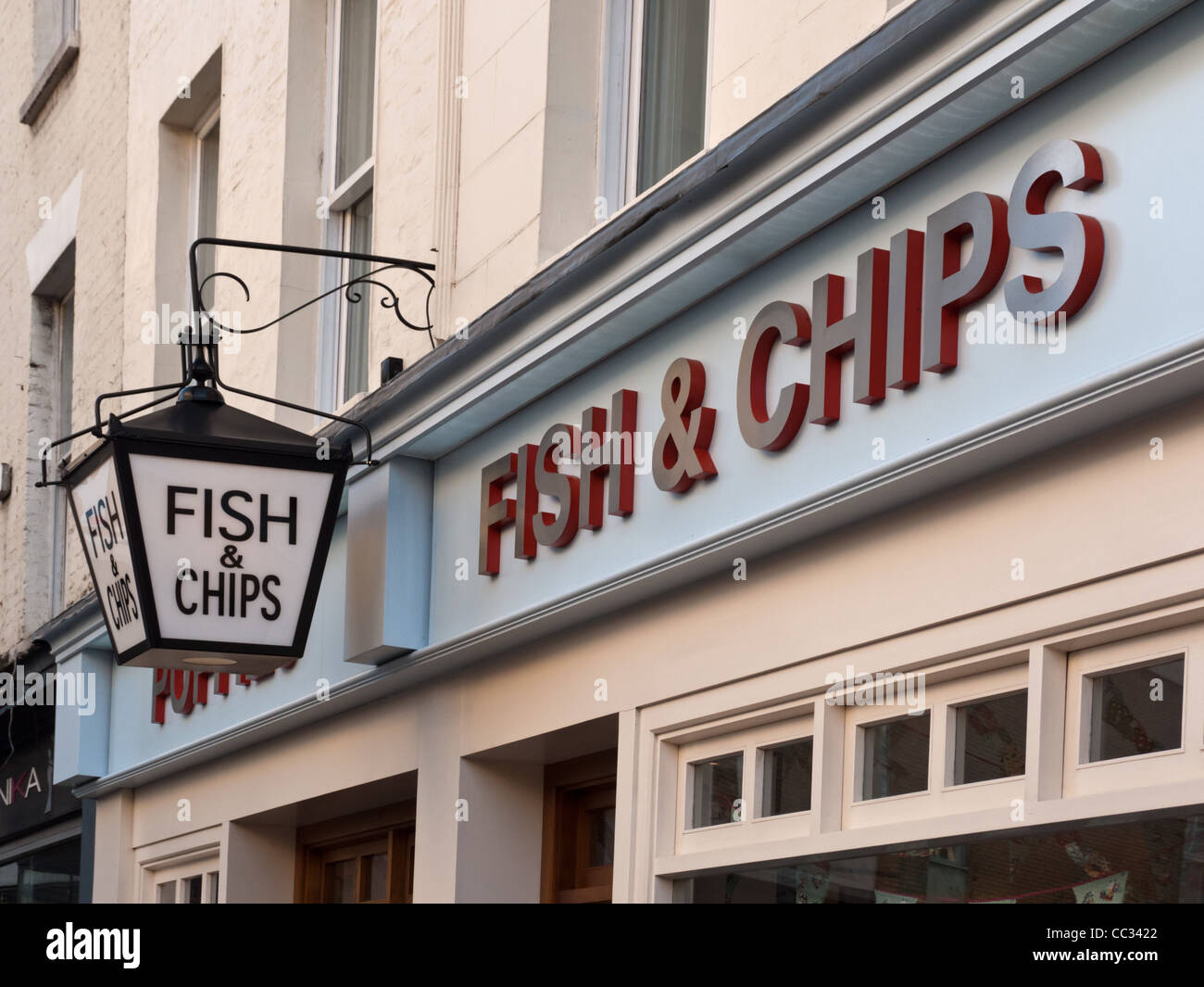Sign outside of a fish and chip shop Stock Photo - Alamy