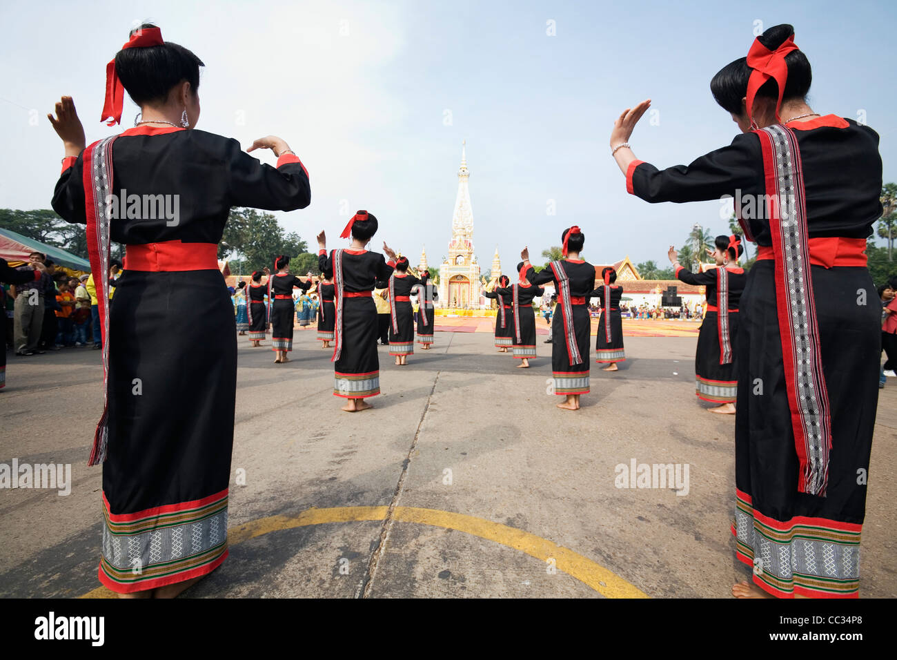 Dancers in traditional Isan dress perform in front of Wat Phra That ...