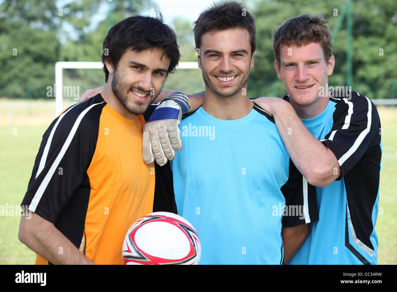 three football players in casual clothes posing for the photo Stock ...