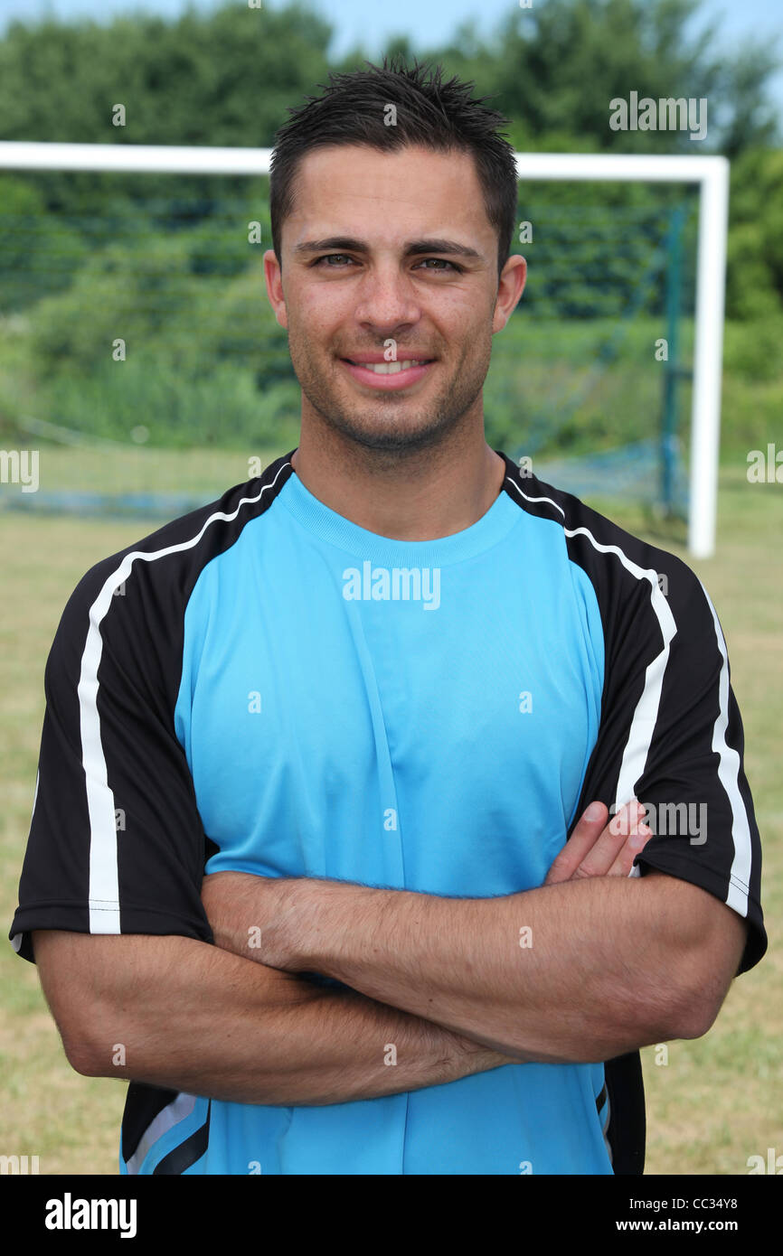 Football player stood on pitch Stock Photo - Alamy
