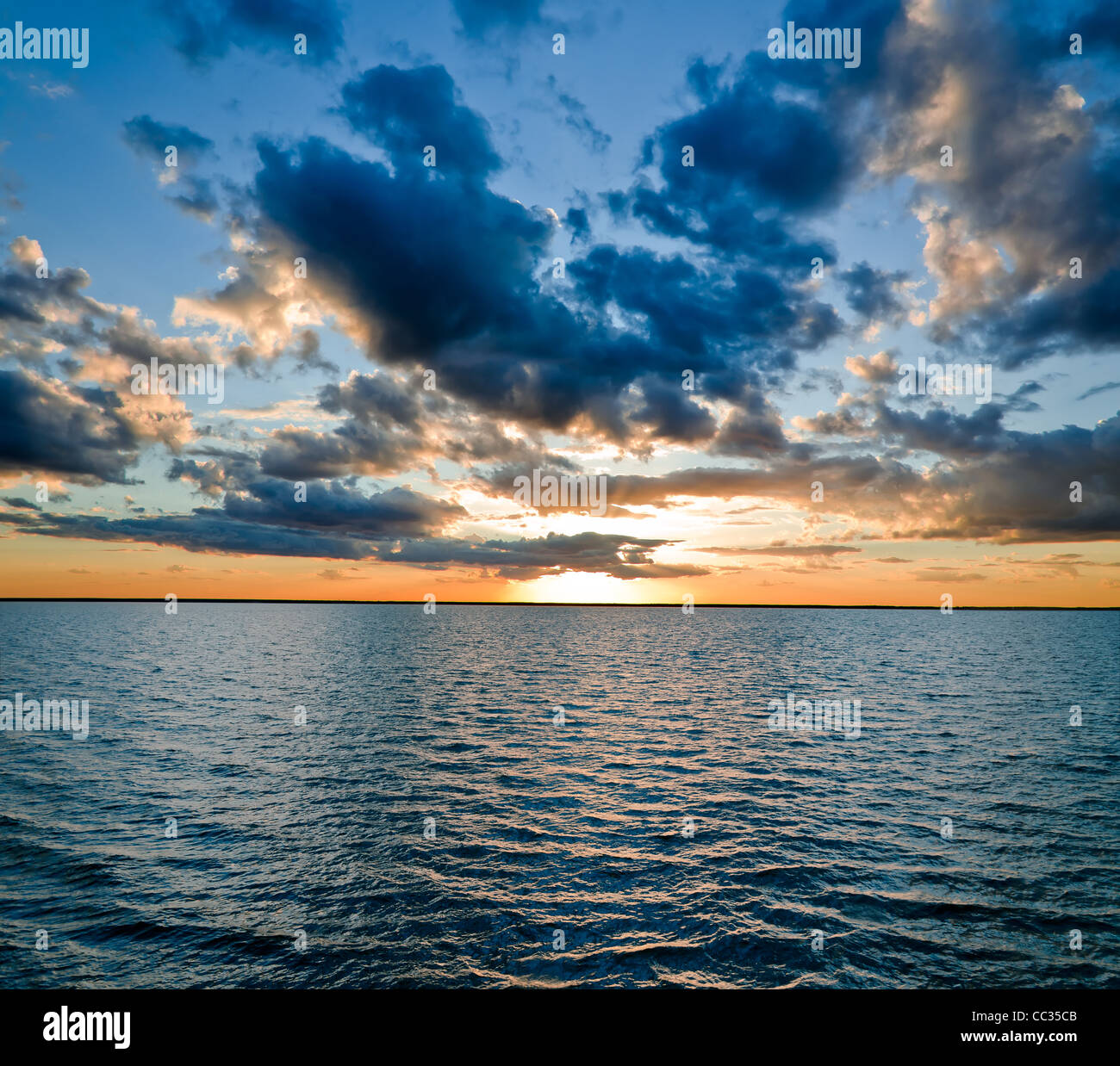 beautiful sunset over the smooth surface of a mountain lake Stock Photo ...