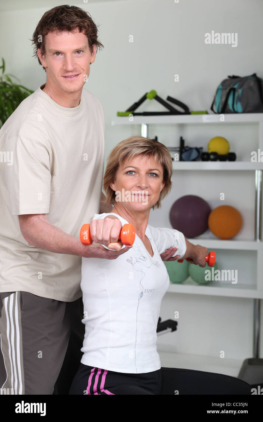 Trainer assisting client hi-res stock photography and images - Alamy