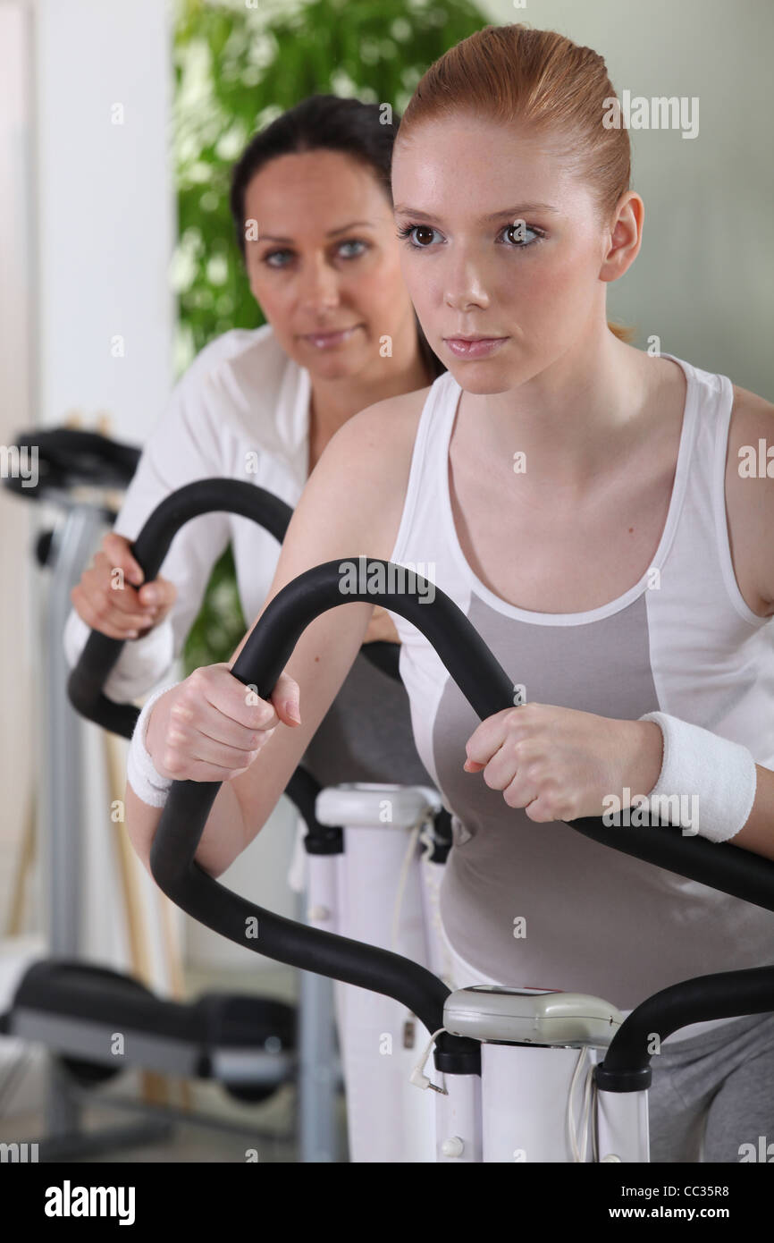 Women using exercise machines at the gym Stock Photo - Alamy
