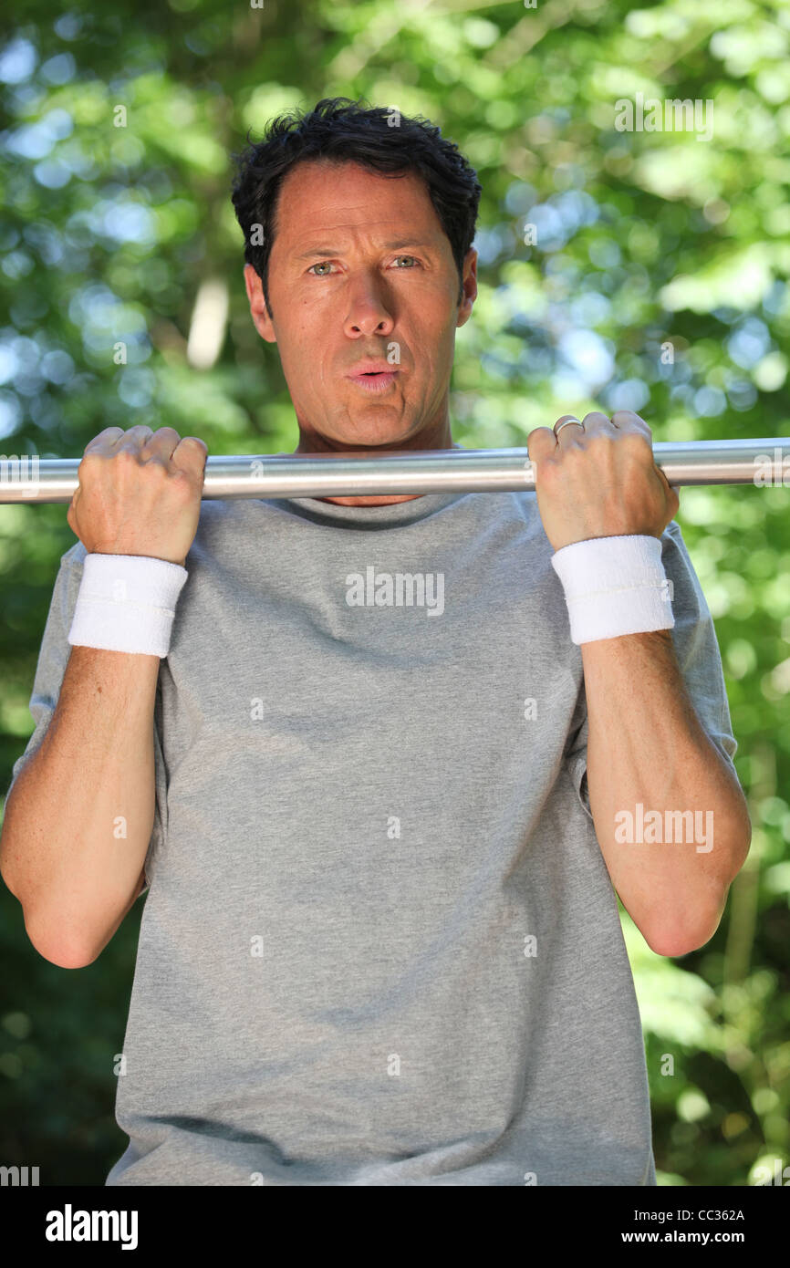 Man doing chin-ups Stock Photo - Alamy