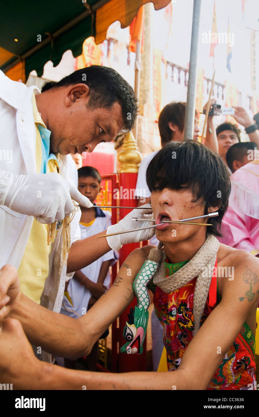 Ma-Thong getting his cheeks pierced as an act of religious devotion at ...
