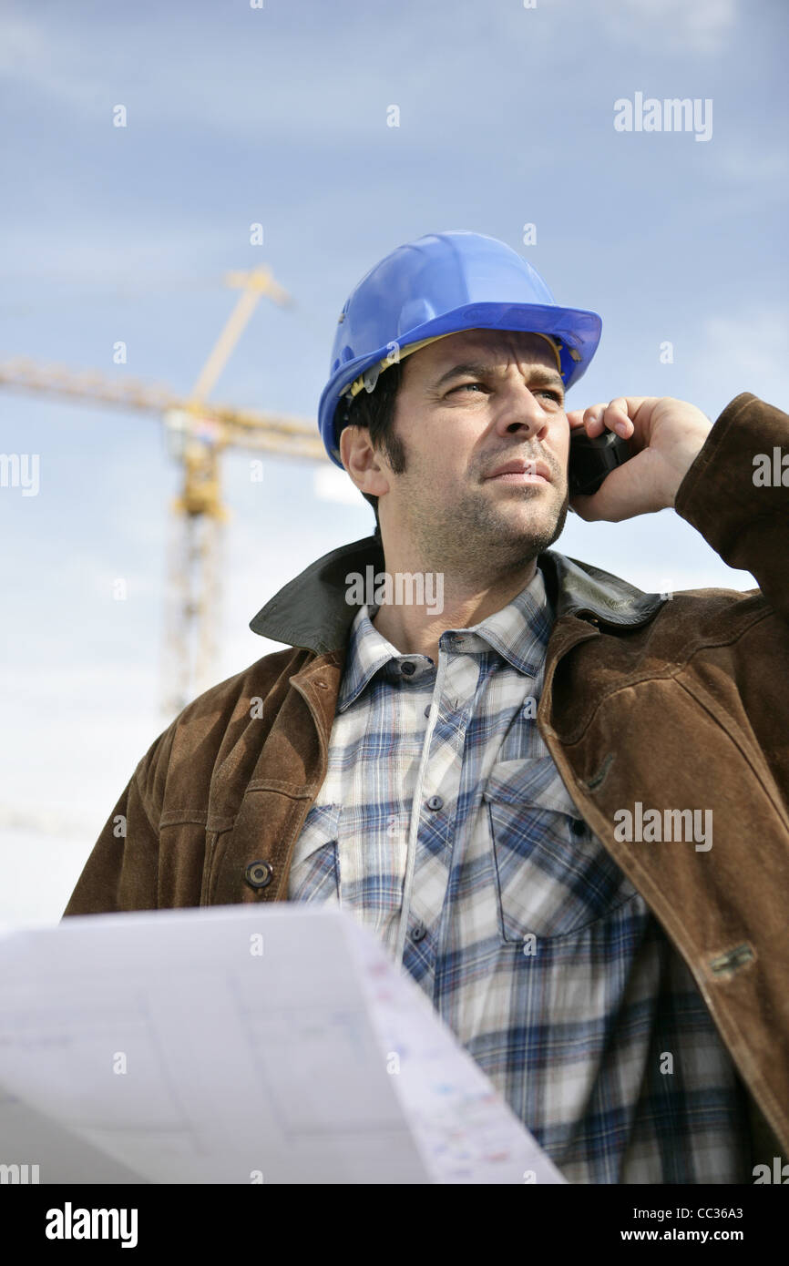Foreman with a laptop and phone Stock Photo - Alamy