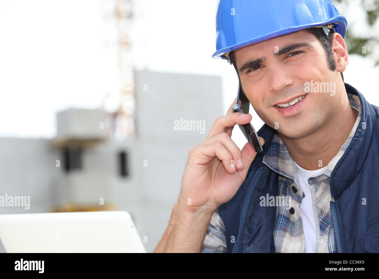 Construction worker using a mobile phone Stock Photo - Alamy