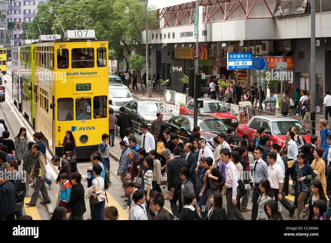 Dense traffic of pedestrians and vehicles during rush hours in the ...