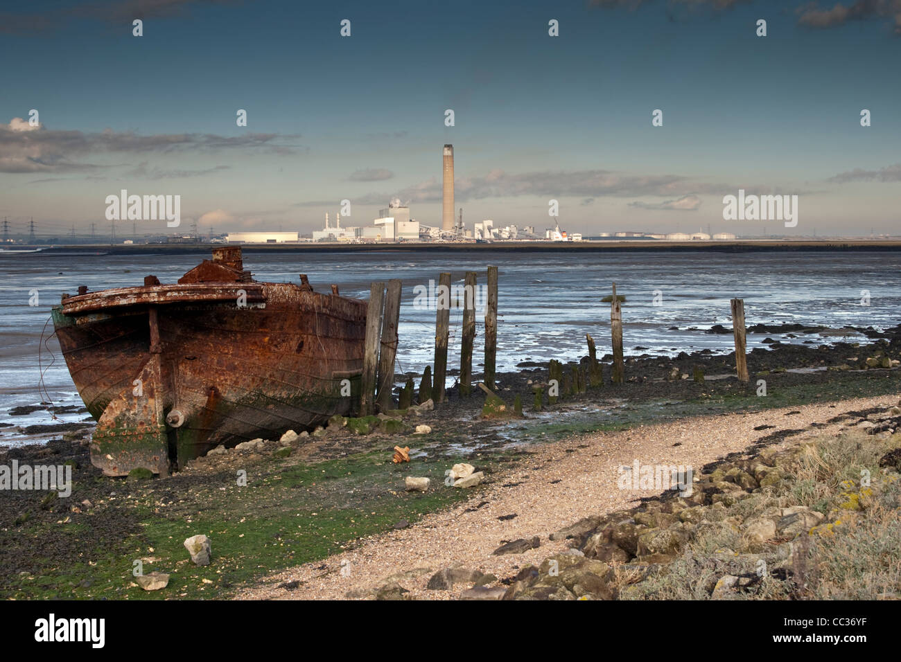 A derelict barge on the River Medway with Kingsnorth power station in ...