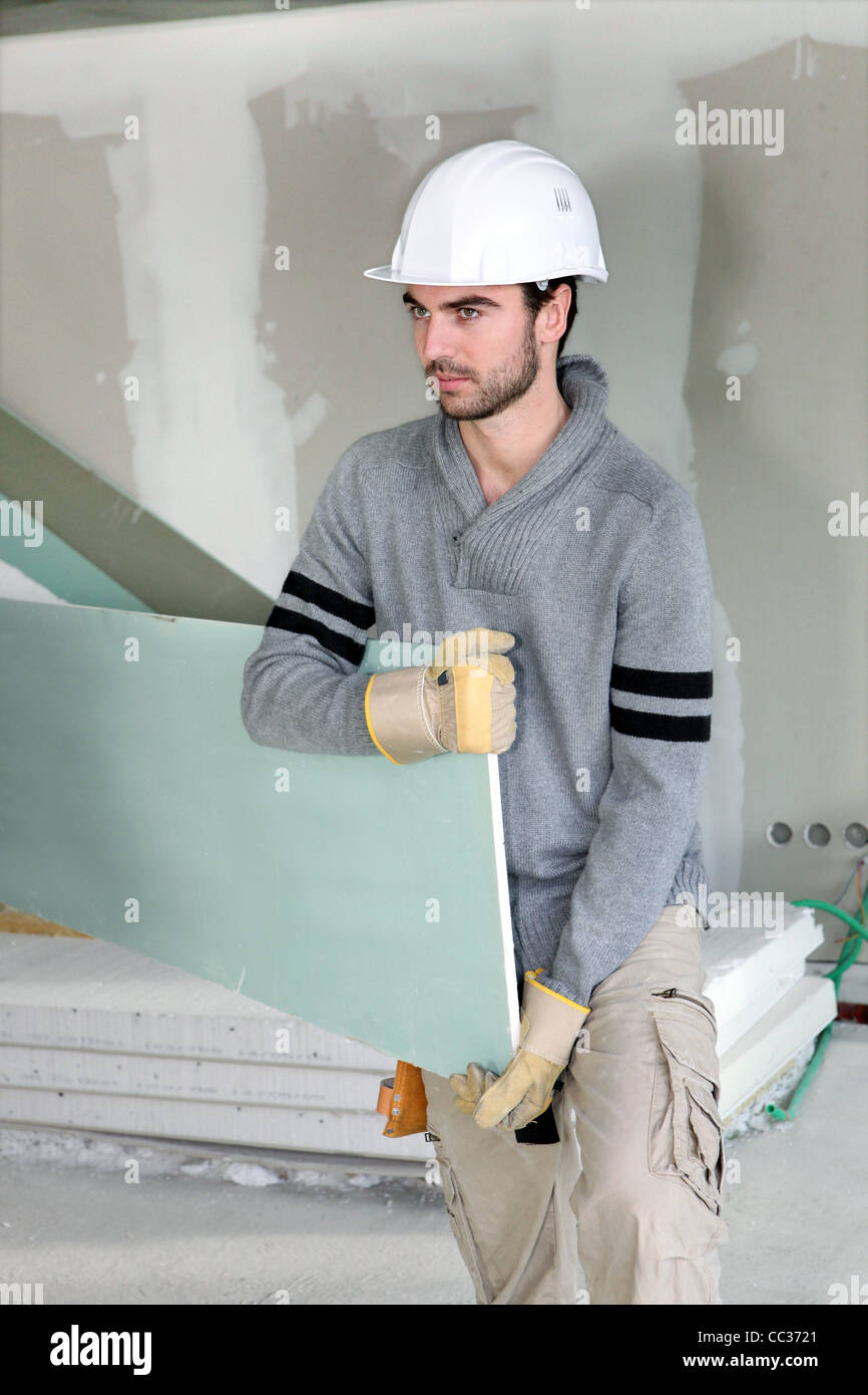 Man carrying plaster-board Stock Photo - Alamy