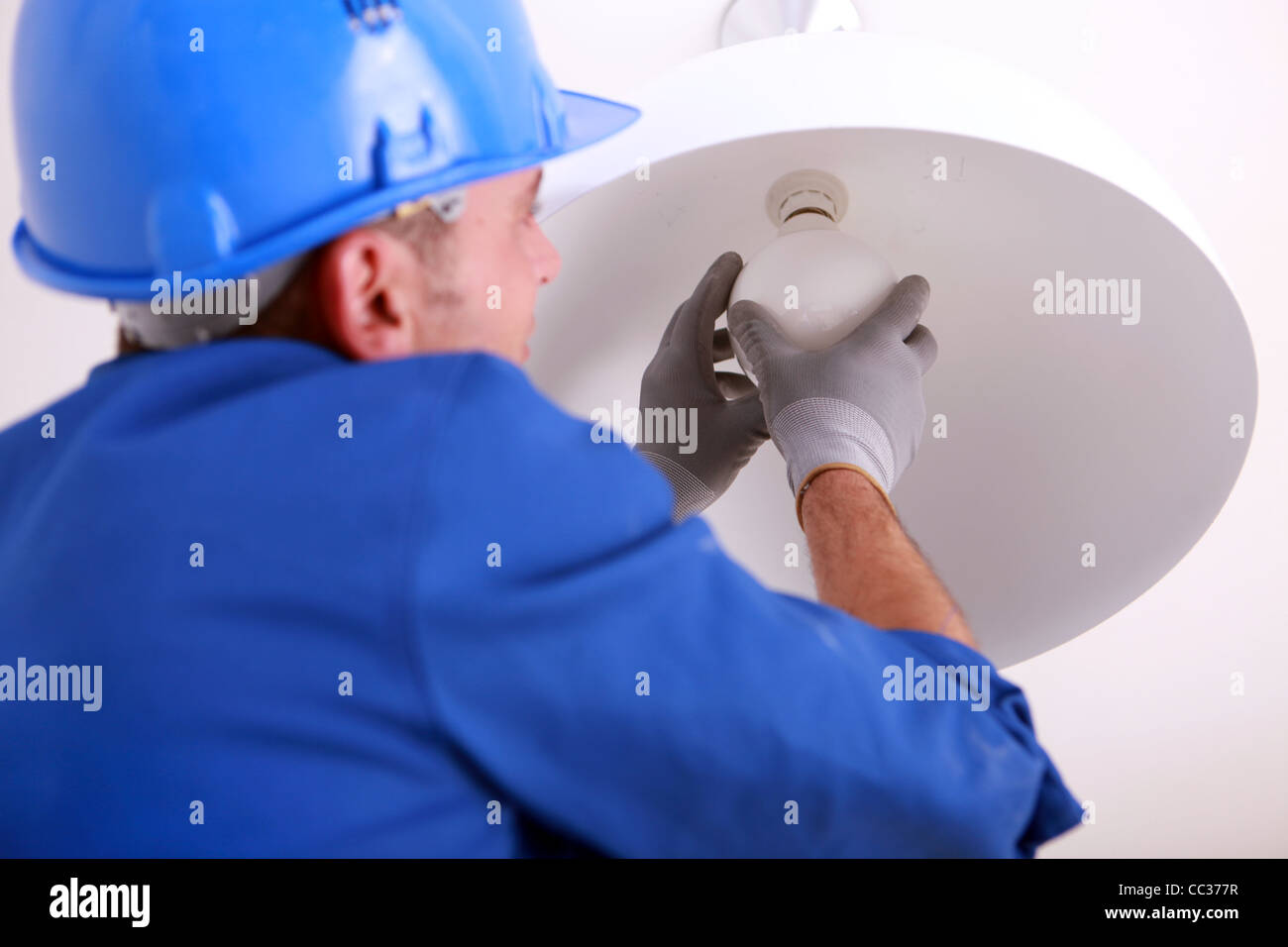 Electrician installing new light bulb Stock Photo - Alamy