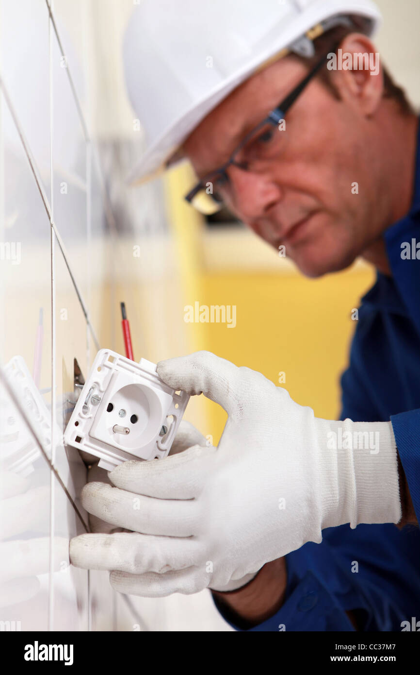 Electrician fitting electrical outlet Stock Photo - Alamy