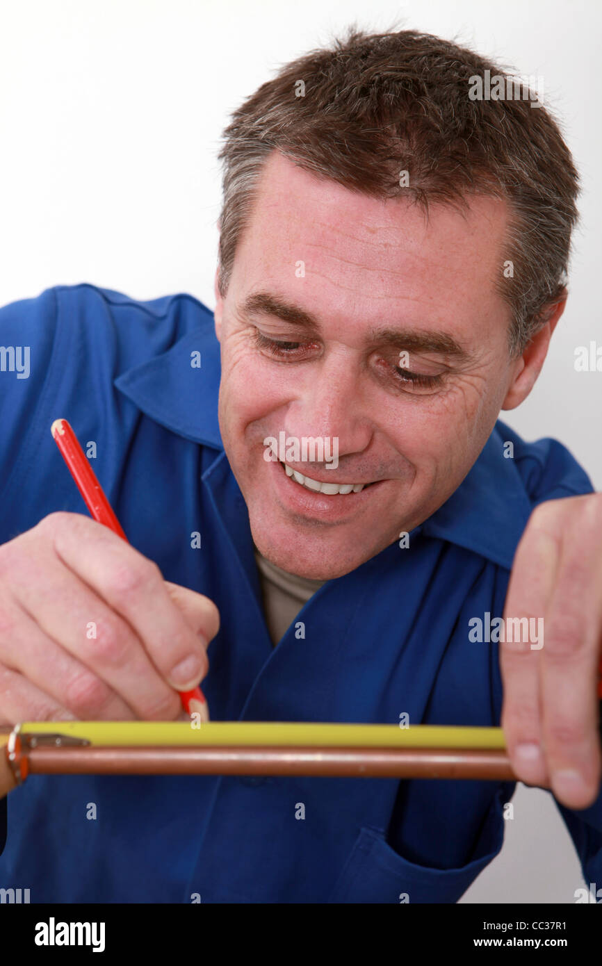 Plumber measuring copper pipe Stock Photo - Alamy