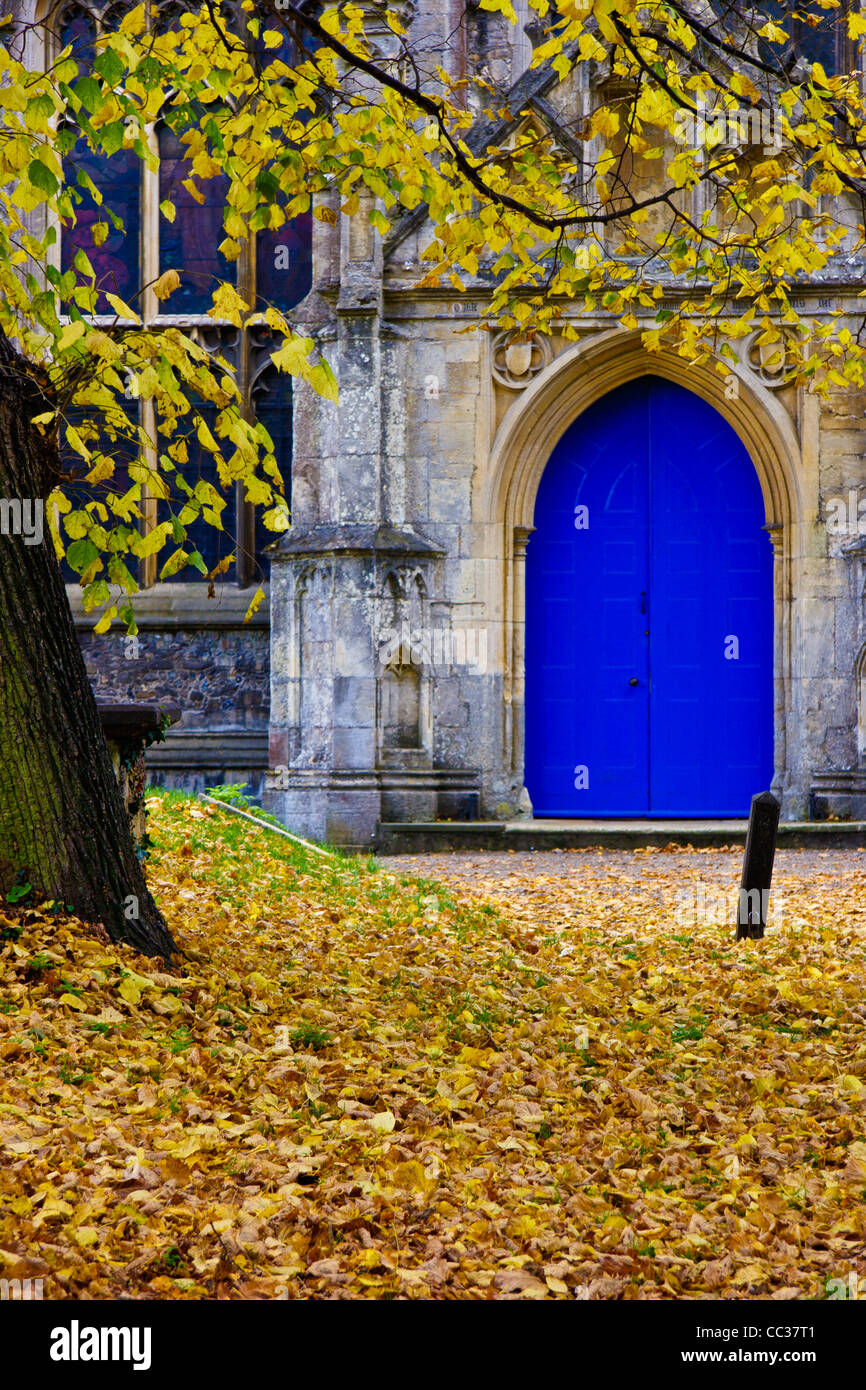 Churchyard and blue church door in Autumn or Fall in Suffolk, England ...