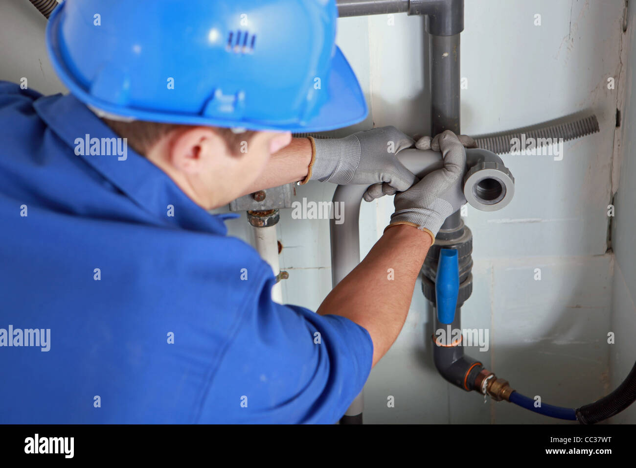 Plumber installing pipes Stock Photo - Alamy