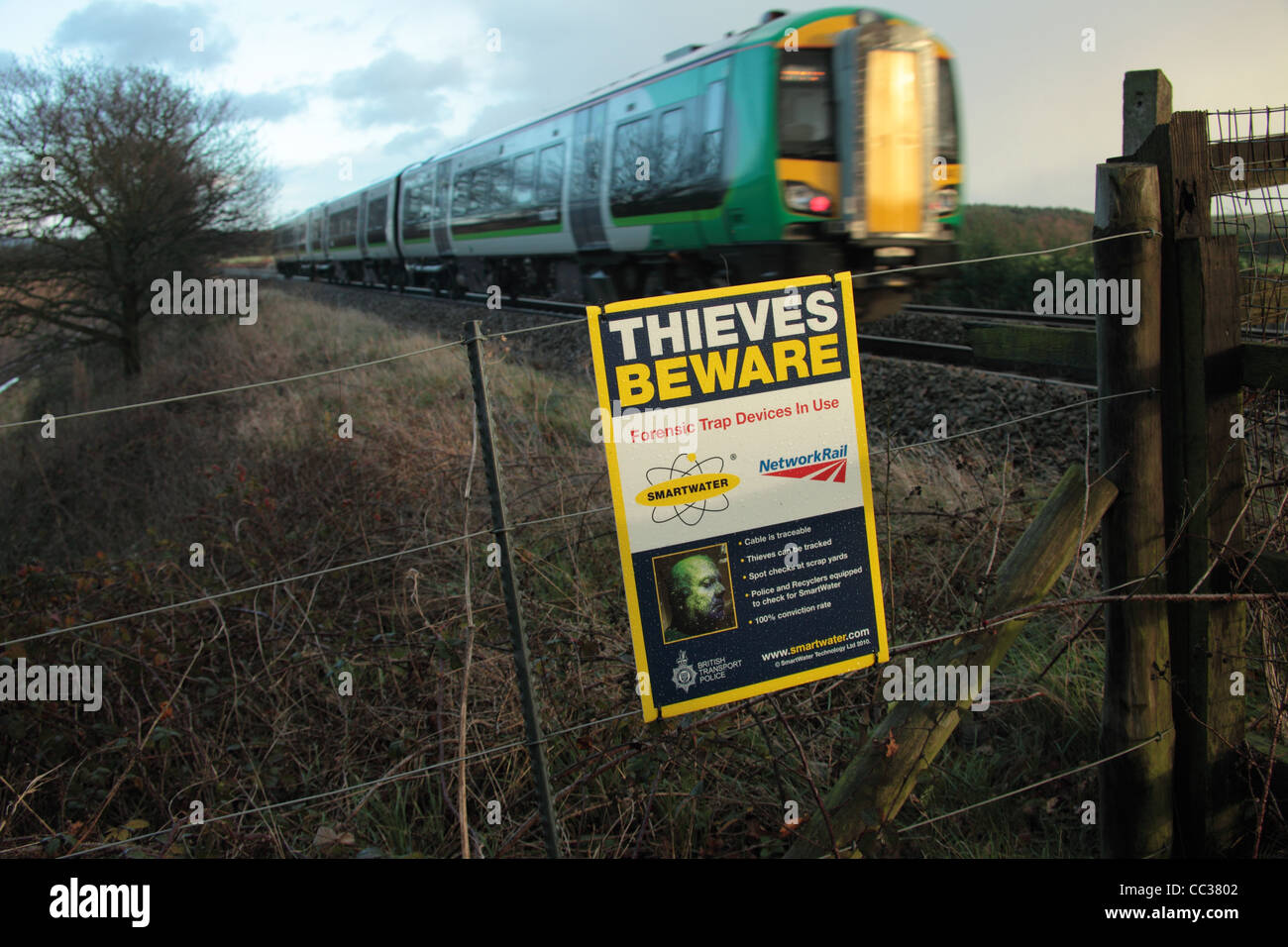 Sign by a railway line which warns against theft of metals as there are ...