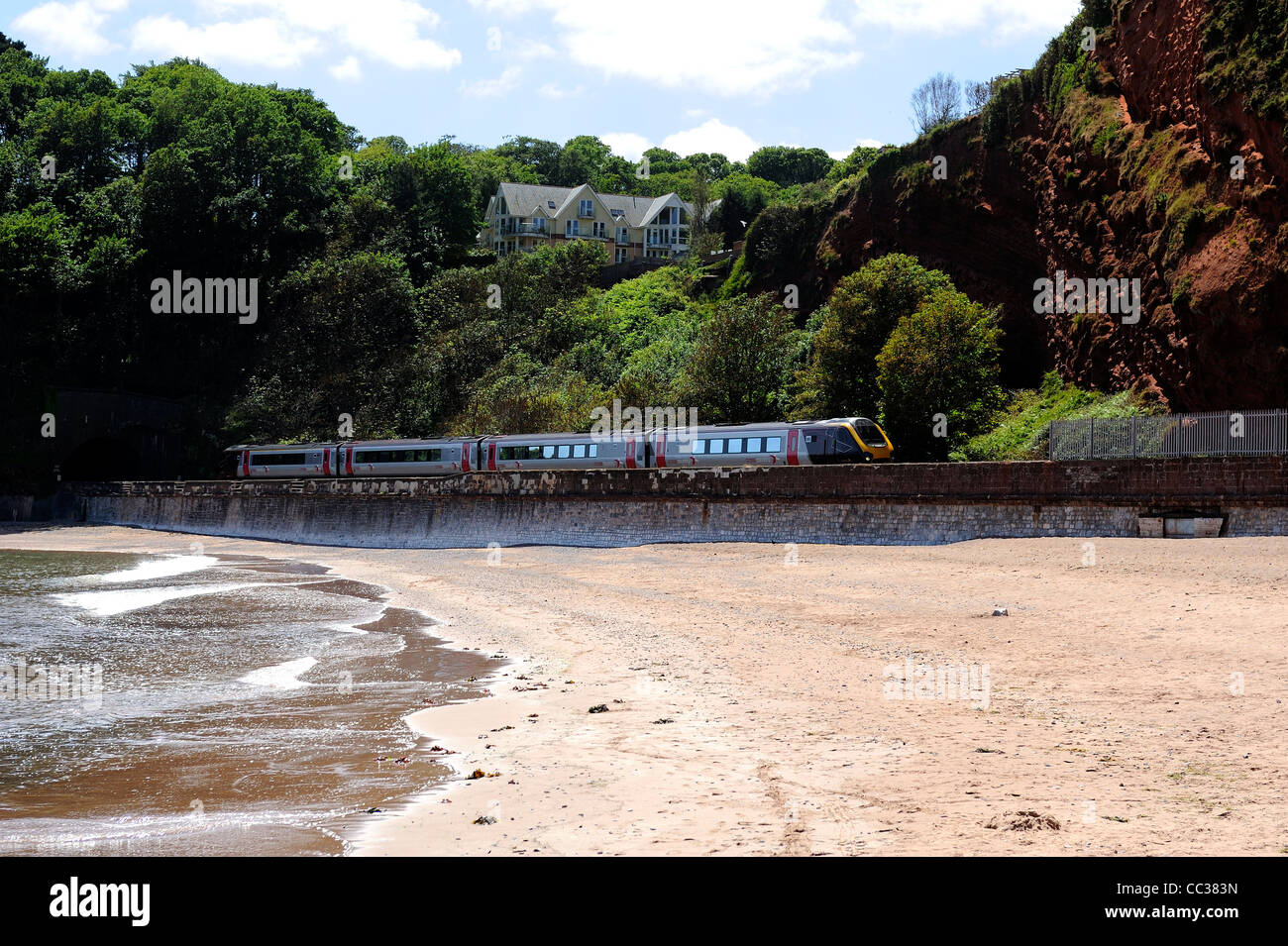 coryton cove beach with express train heading for dawlish devon england ...
