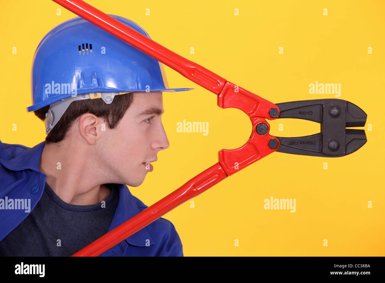 Young man with boltcutters Stock Photo - Alamy
