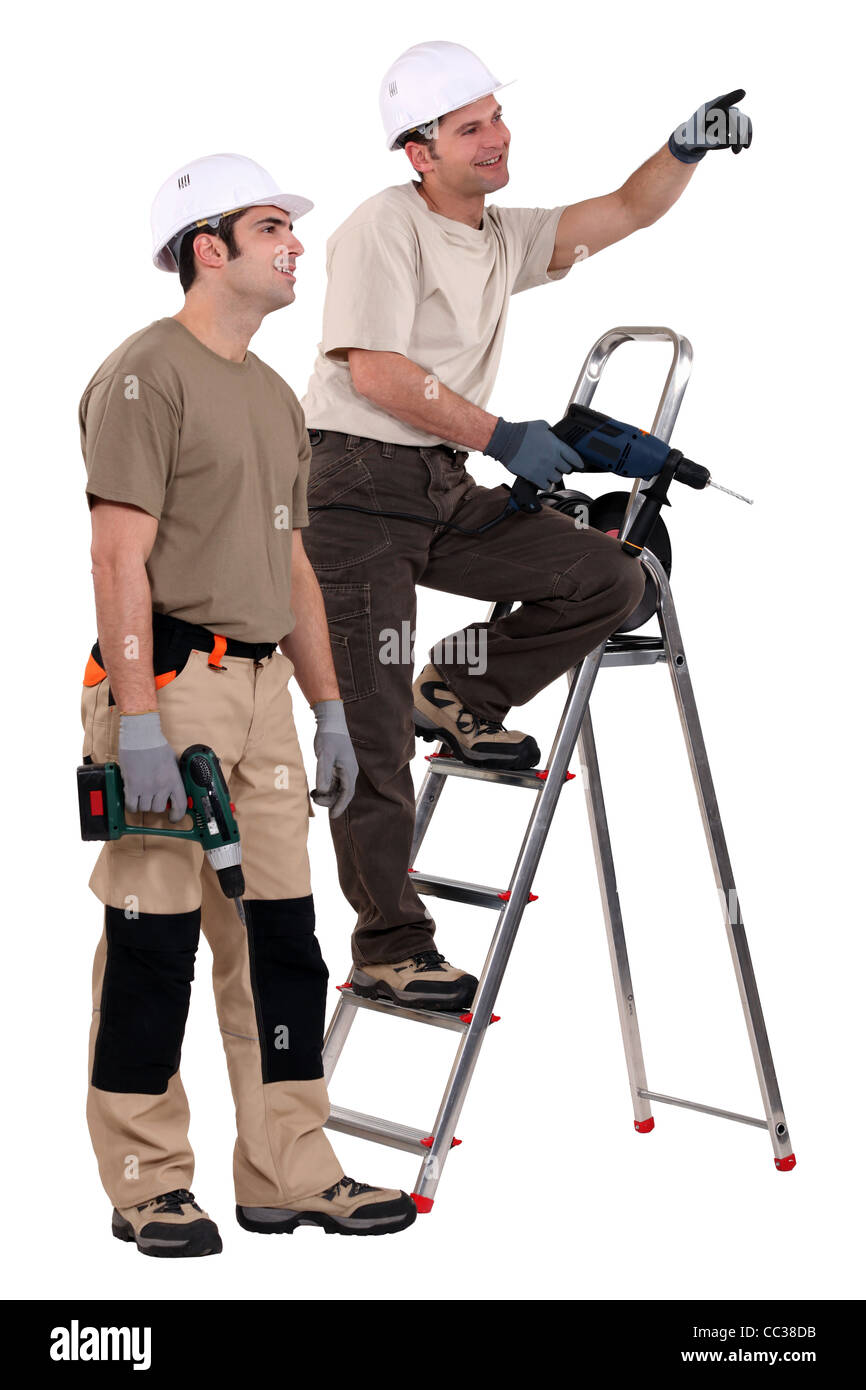 Two laborers with drills chatting Stock Photo - Alamy